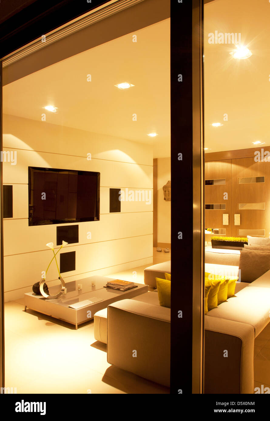 Illuminated living room of modern home Stock Photo - Alamy
