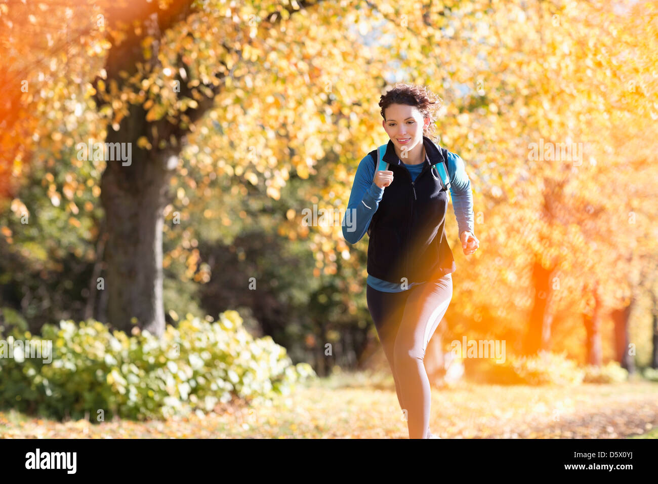 Woman running in park Stock Photo - Alamy