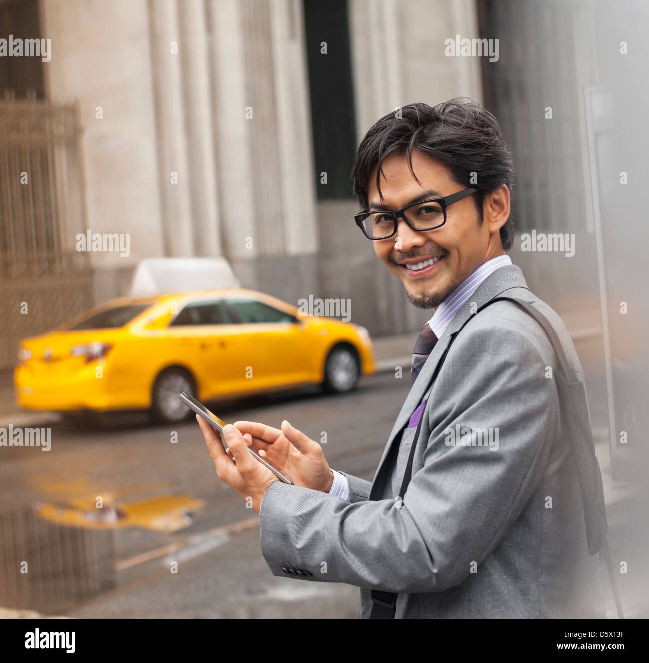Businessman using cell phone on city street Stock Photo - Alamy