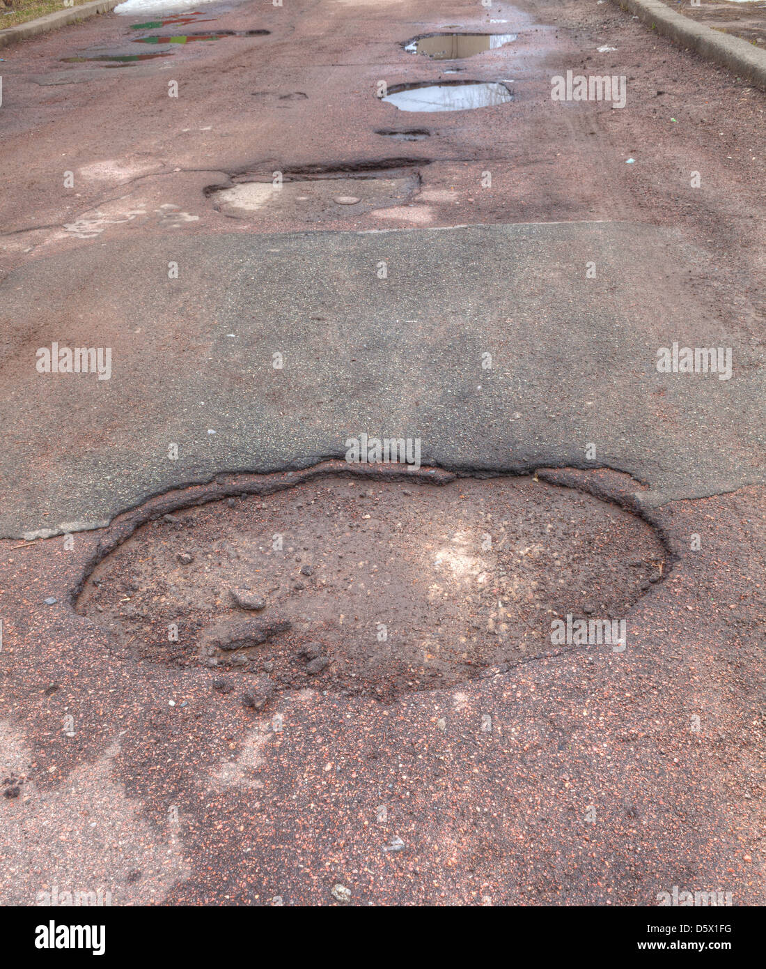 Pothole in road after spring thaw Stock Photo - Alamy