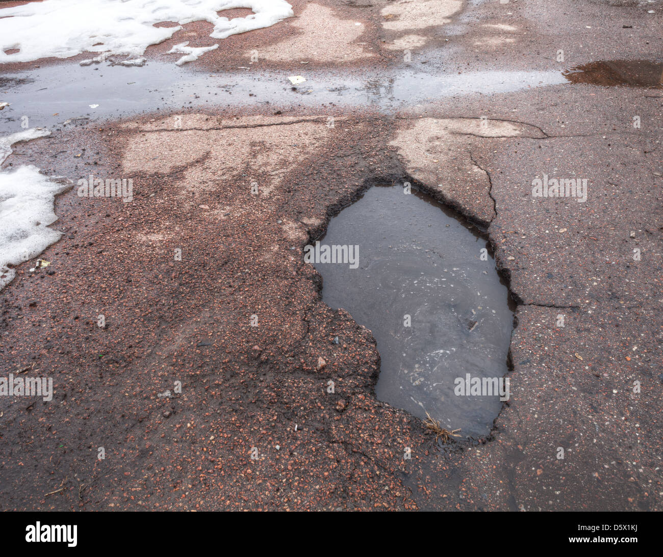 Pothole in road after spring thaw Stock Photo - Alamy