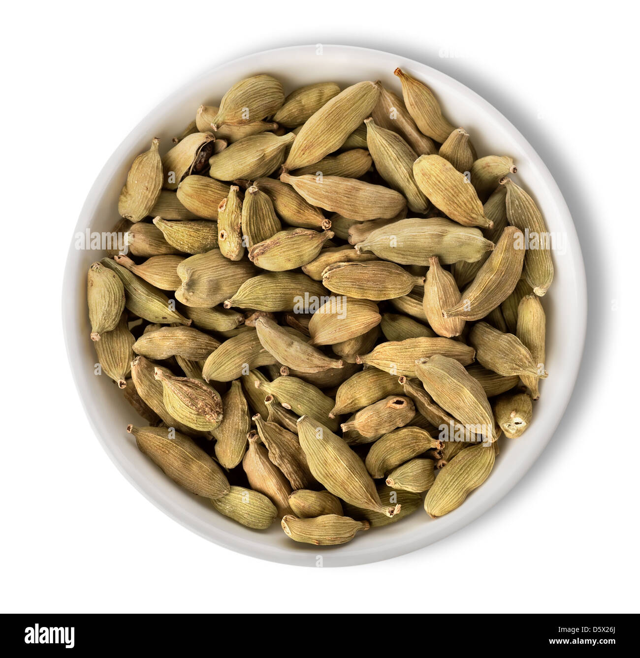 Cardamom in plate isolated on white background Stock Photo - Alamy