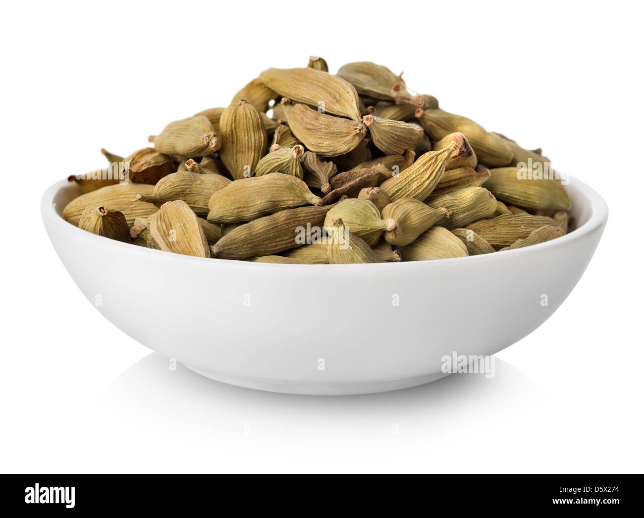 Cardamom in plate isolated on white background Stock Photo - Alamy