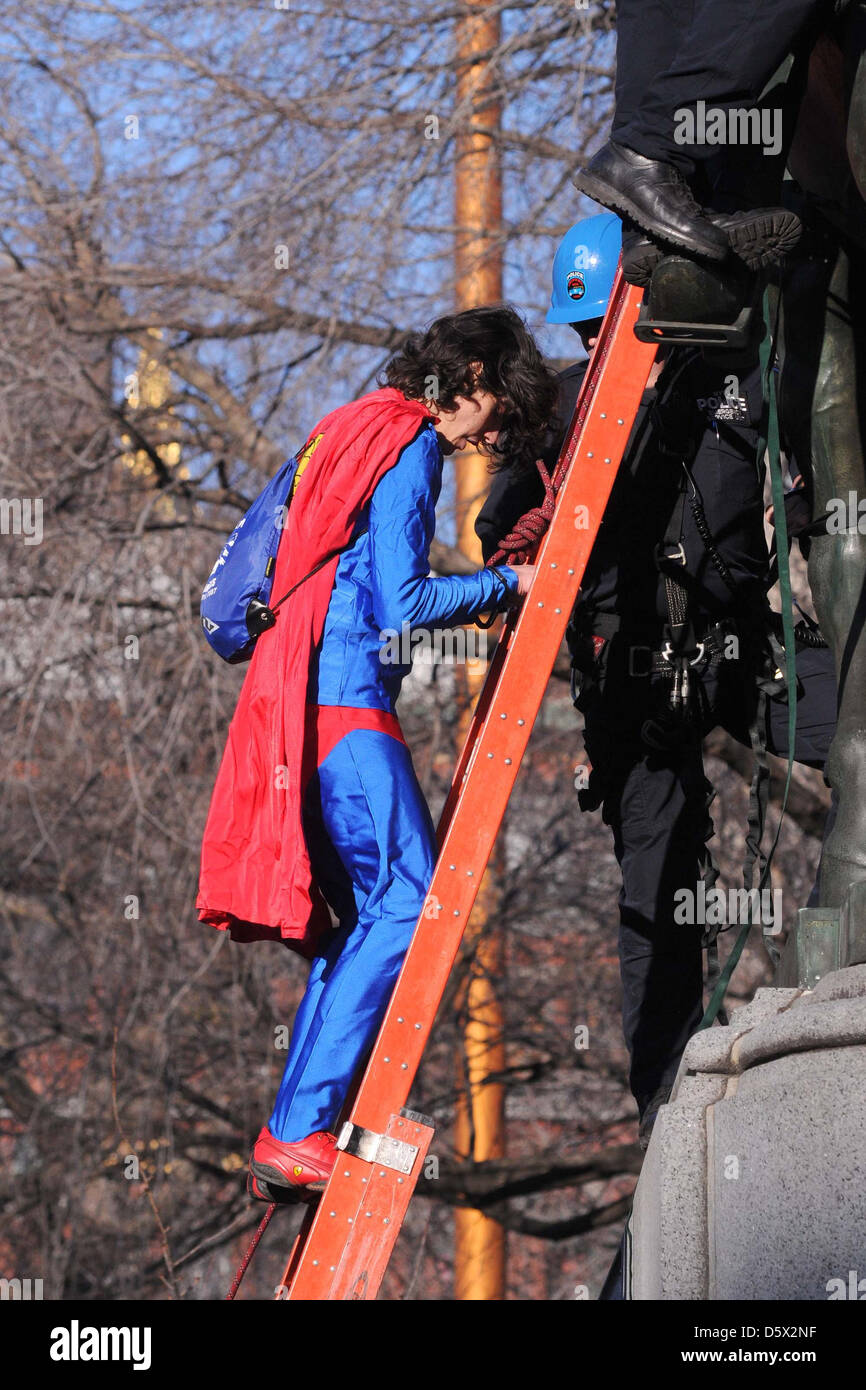 A man dressed in a Superman costume protests against social ...