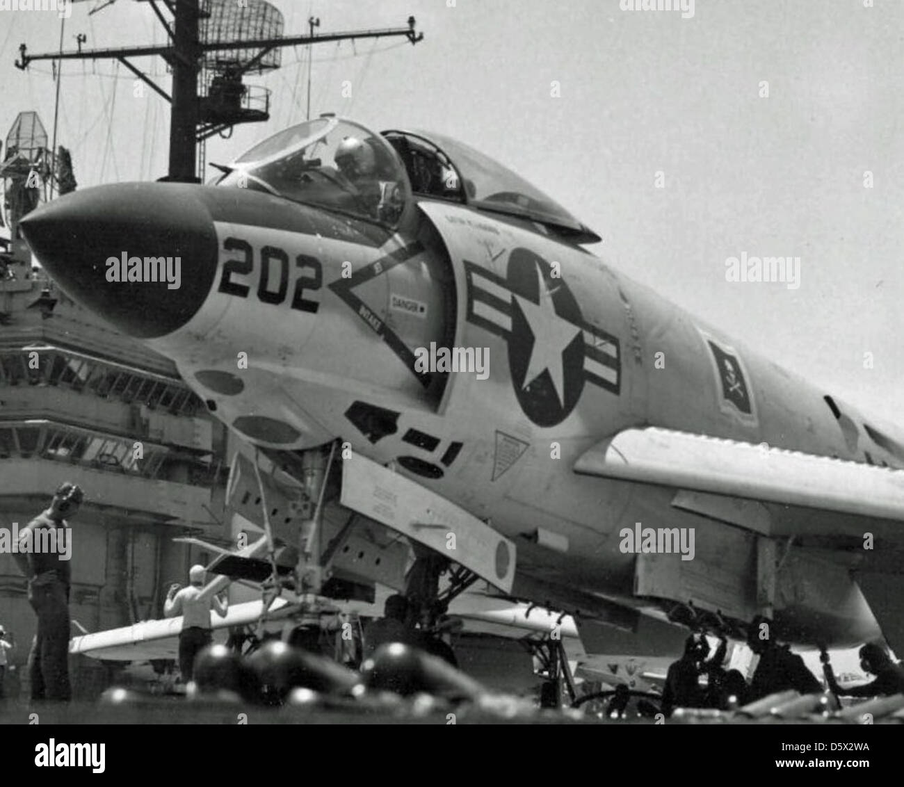A McDonnell F3H-2M Demon of Fighter Squadron 61 is seen being prepared ...