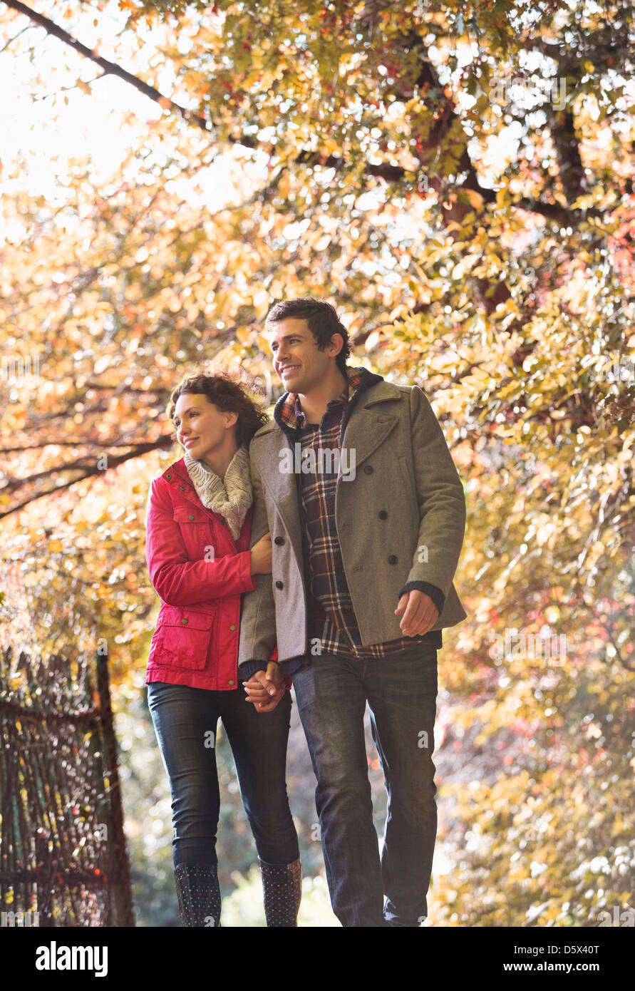 Couple walking together in park Stock Photo - Alamy