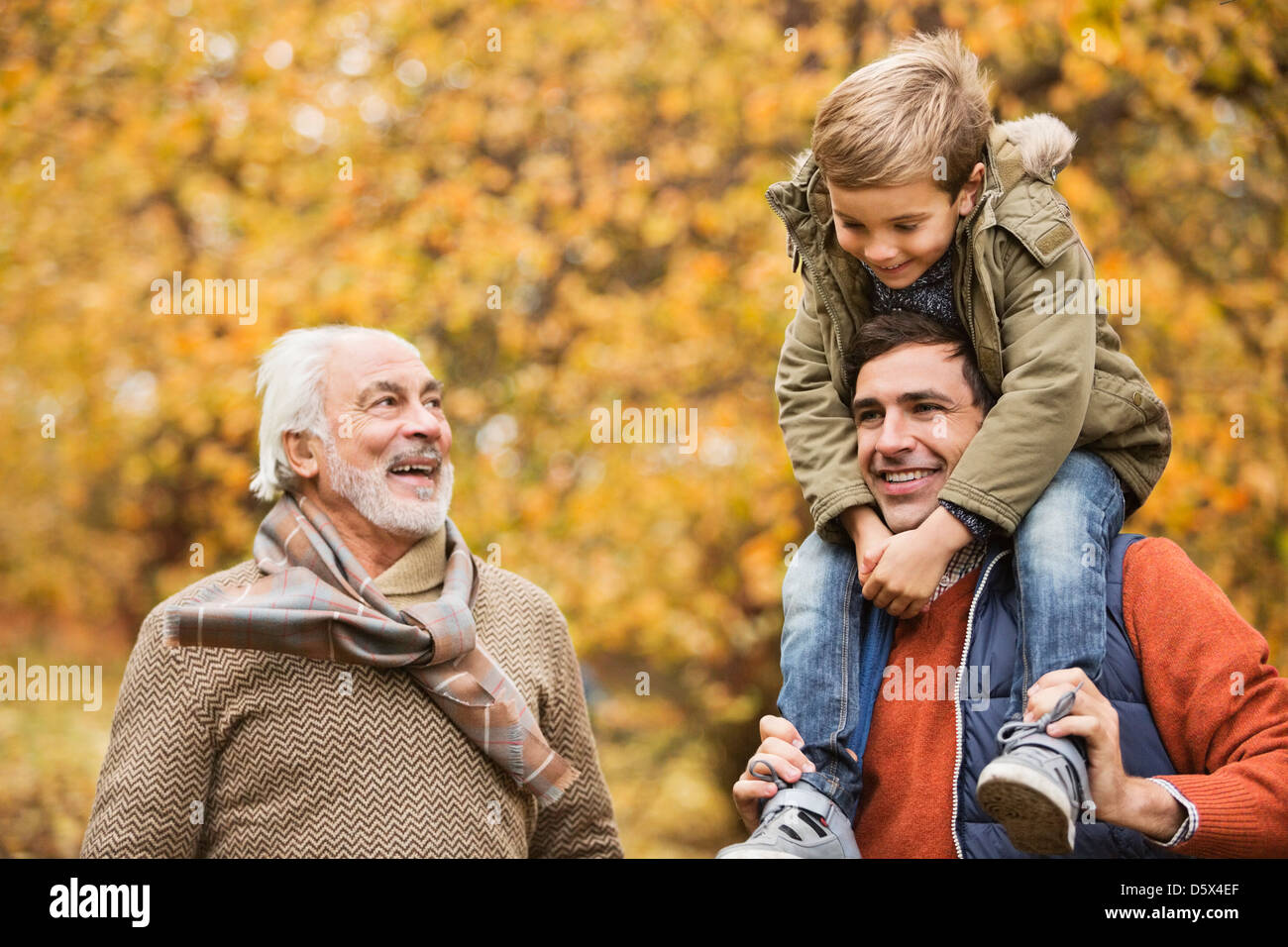 Three generations of men smiling in park Stock Photo - Alamy