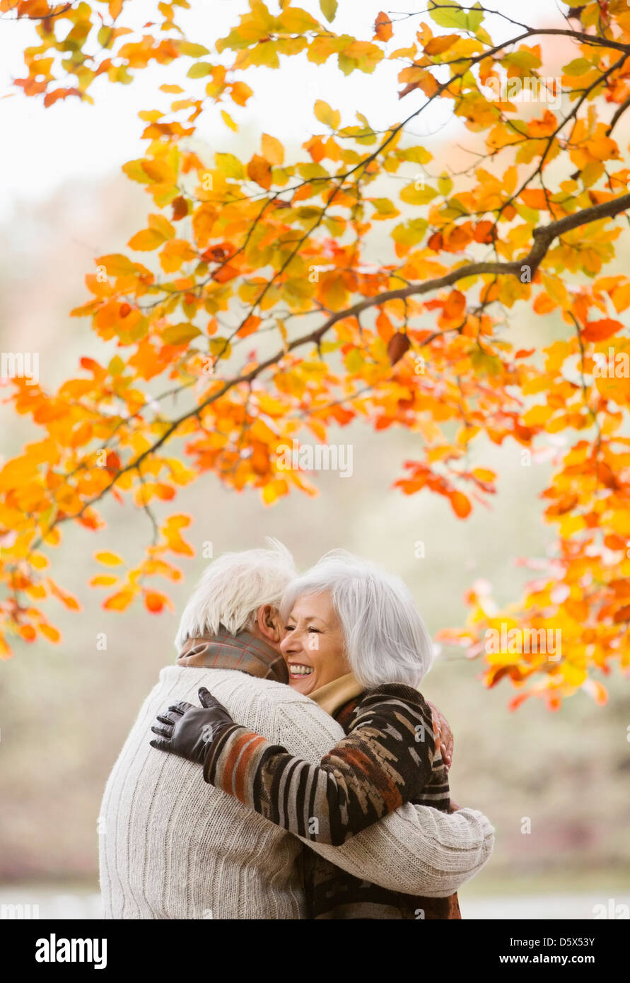 Older couple hugging in park Stock Photo - Alamy