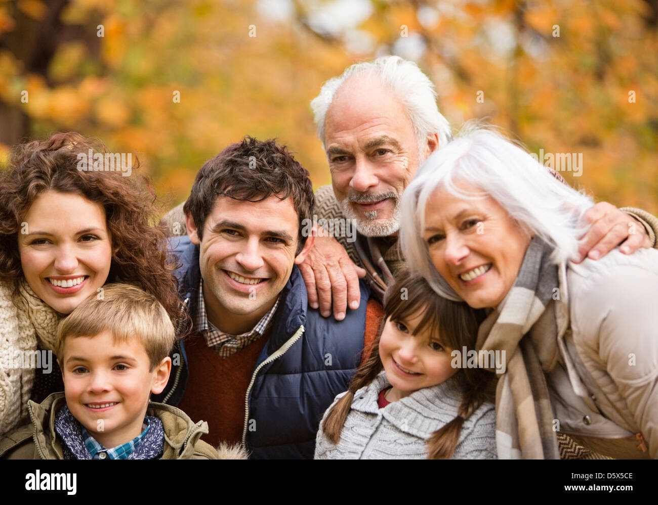 Family smiling together in park Stock Photo - Alamy