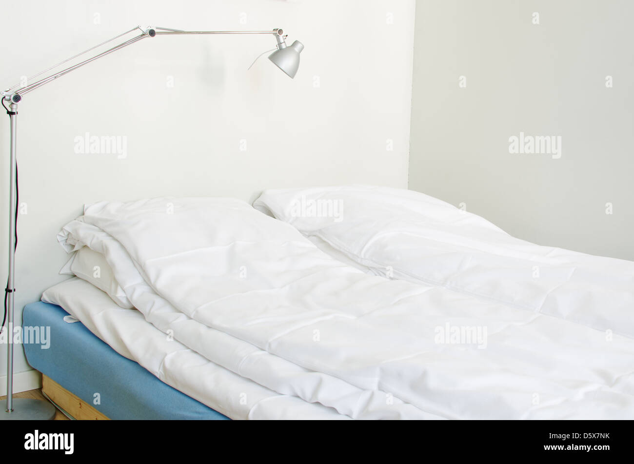 bedroom with a bed and lamp Stock Photo - Alamy