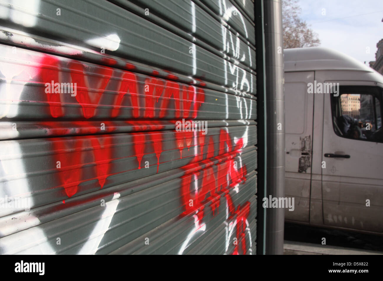 www painted on shop door shutters in rome italy Stock Photo - Alamy