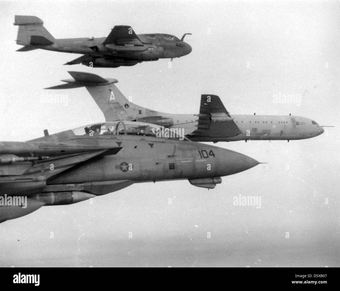A Grumman F-14 Tomcat of VF-14 and an EA-6B Prowler of VAQ-130 conduct ...