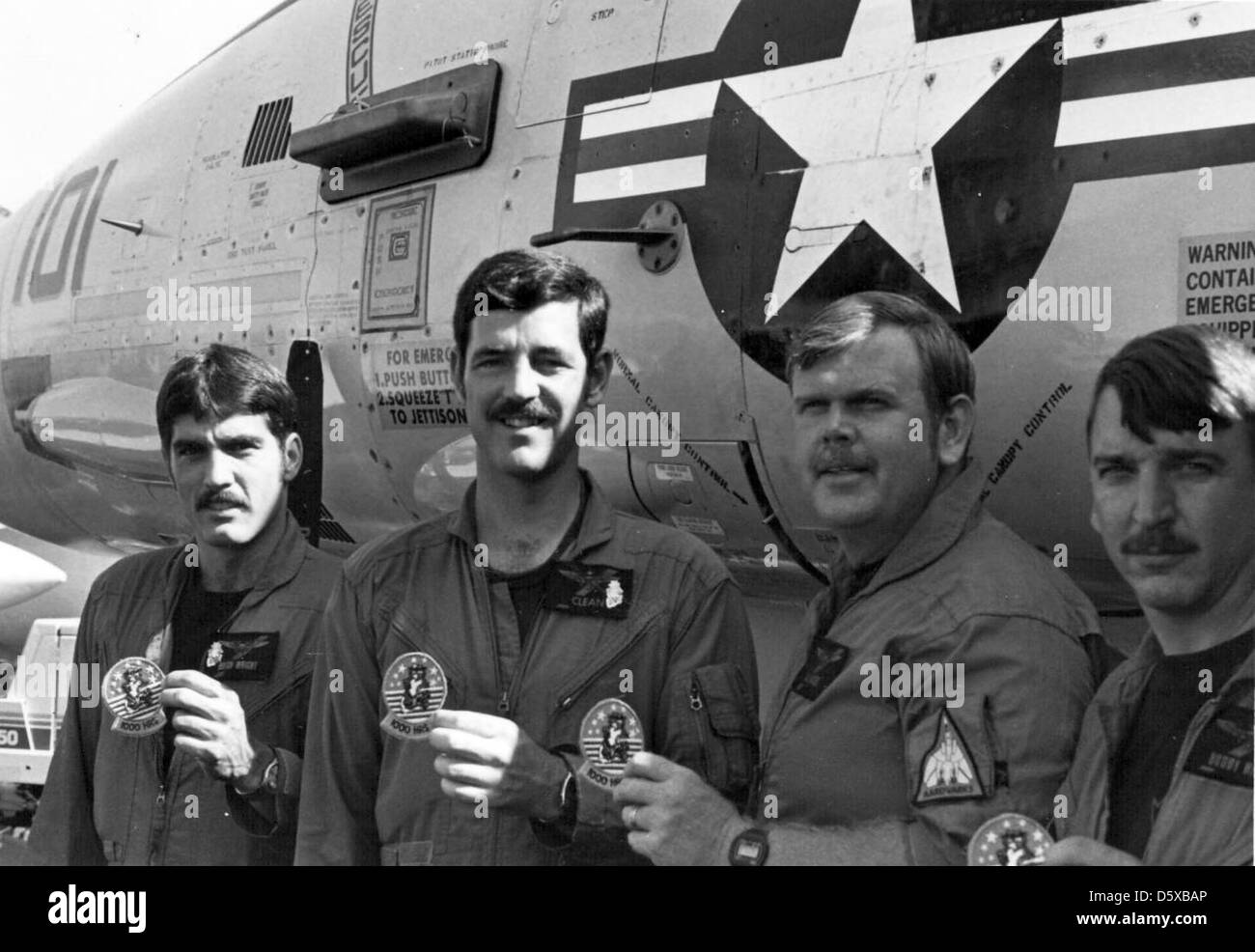 FS (VF) 114 pilots and naval flight officers hold up patches signifying ...