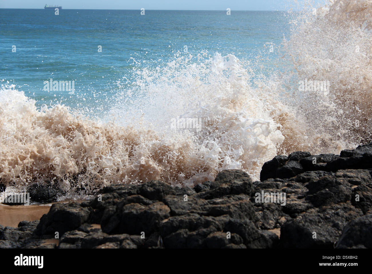 Splashing, foaming white backwash from the Indian Ocean waves breaking ...