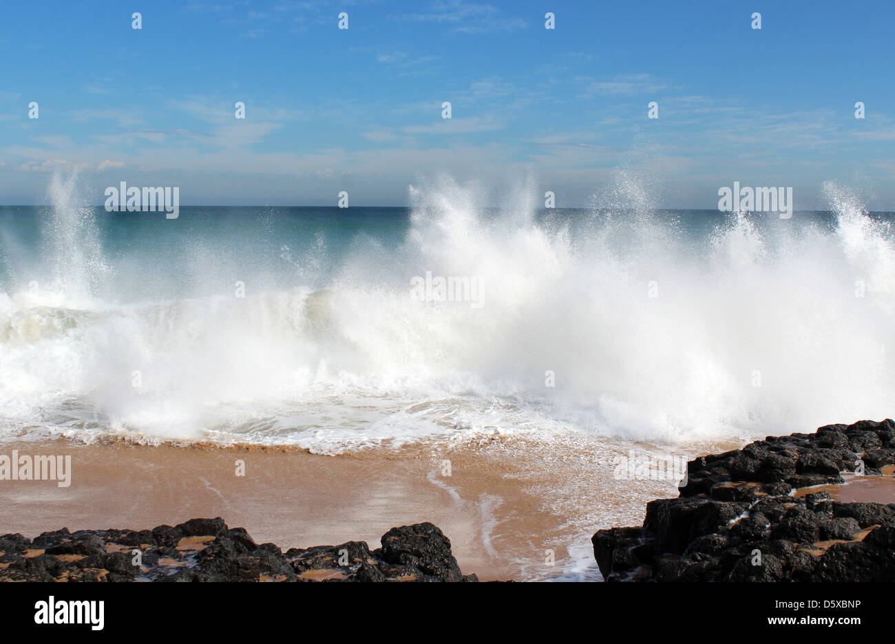 Splashing, foaming white backwash from the Indian Ocean waves breaking ...