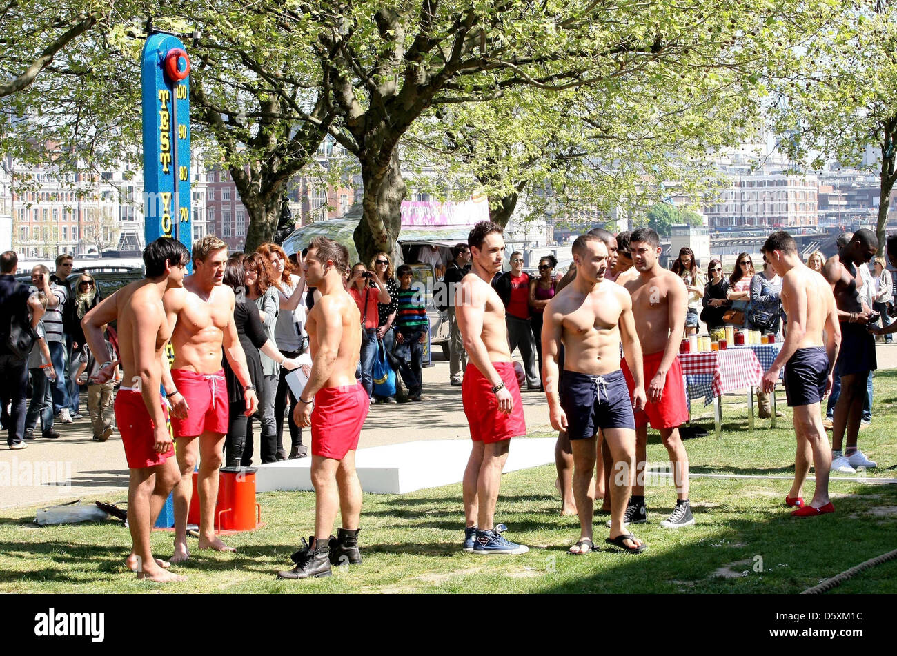 Cast members of 'The Hunks' ITV filming various challenges outside with ...