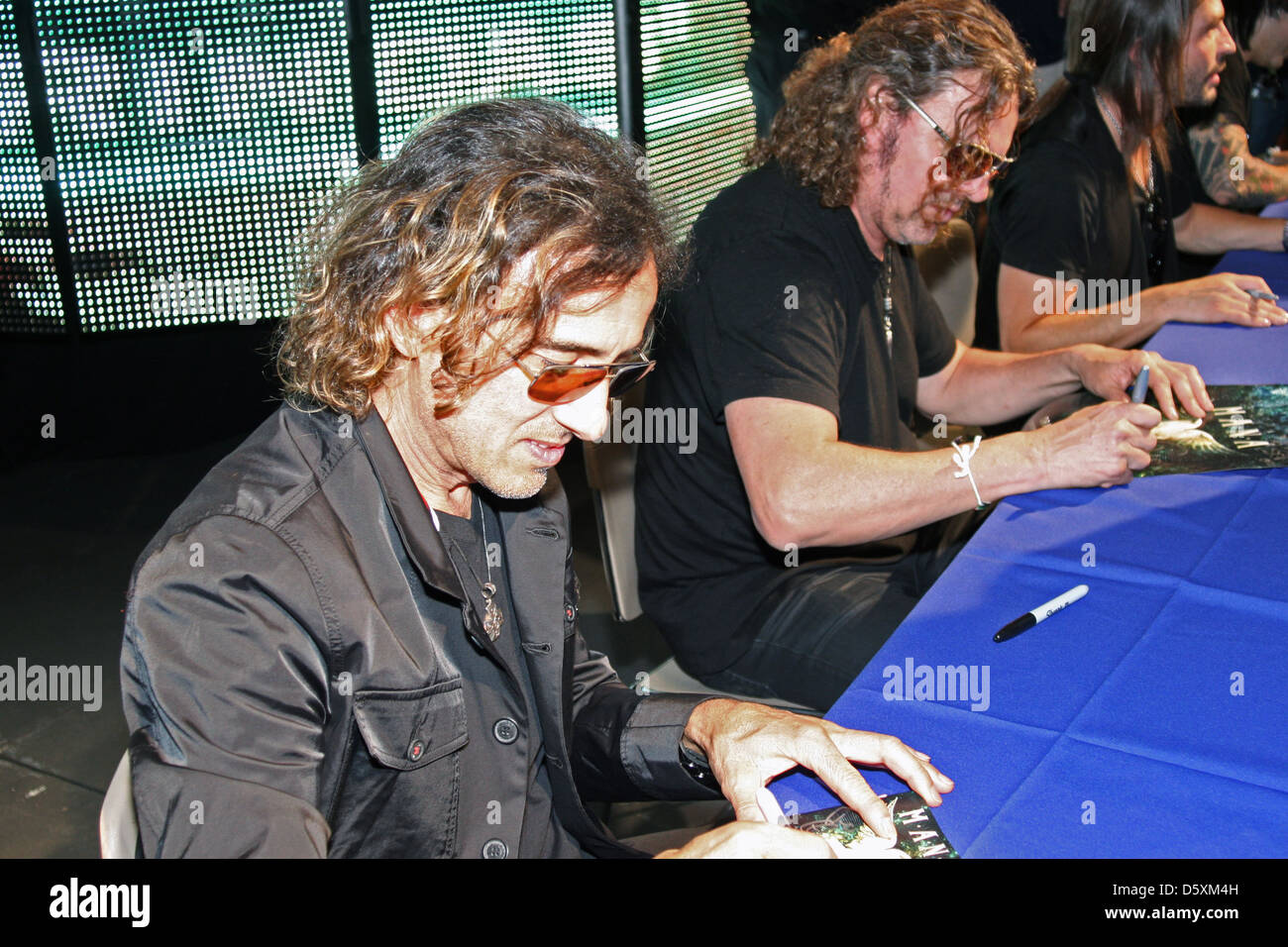 Mexican Latin rock band Mana sign copies of their new album 'Drama y ...