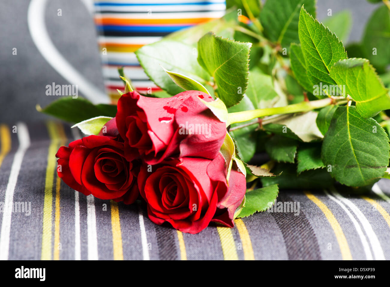 Red roses and cup Stock Photo - Alamy