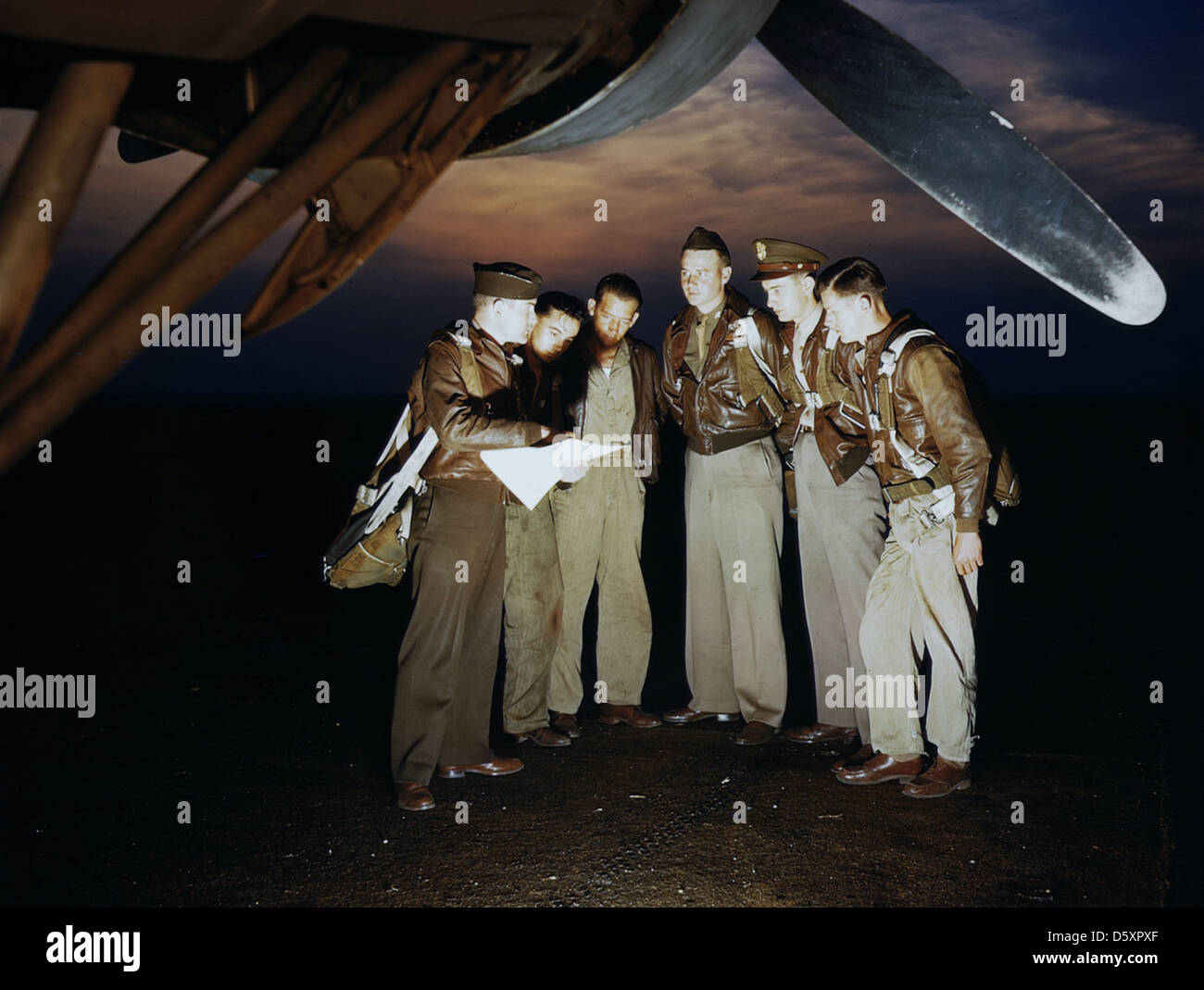 In May 1942, a combat crew receives final instructions before taking ...