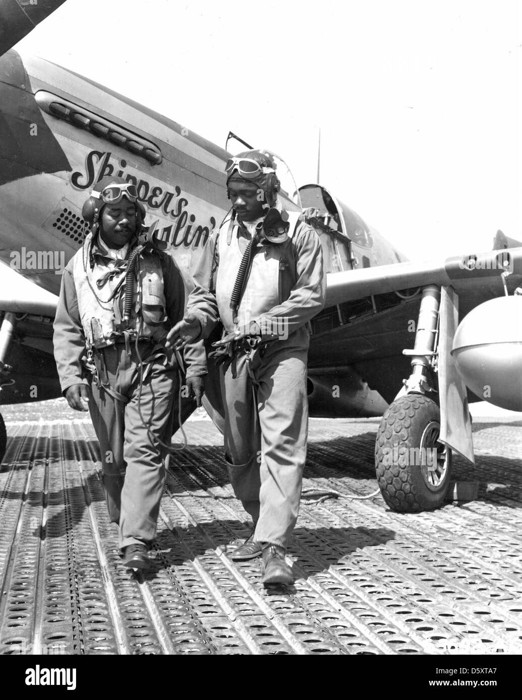 The Tuskegee Airmen, pilots of the 332nd Fighter Group, are shown ...