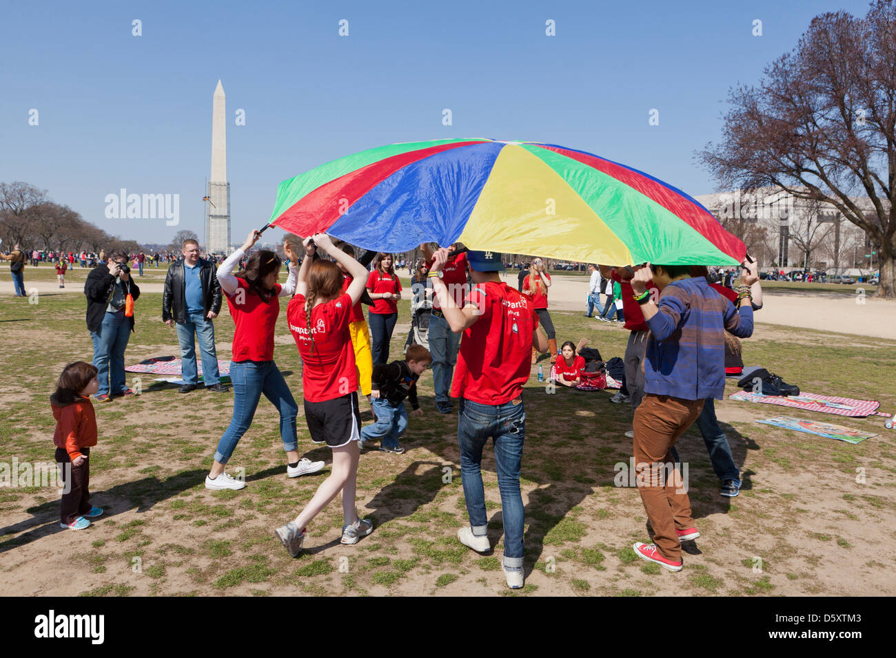 Kids and adults playing parachute tag - Washington, DC USA Stock Photo ...