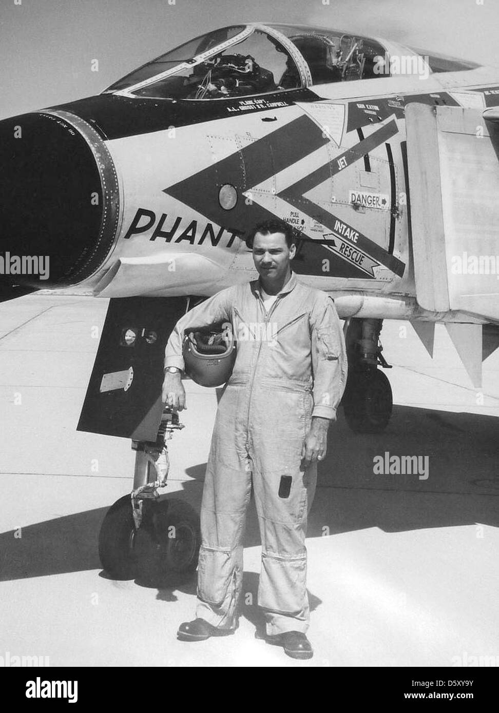 Commander John F. Davis, U.S. Navy test pilot and project officer, is ...