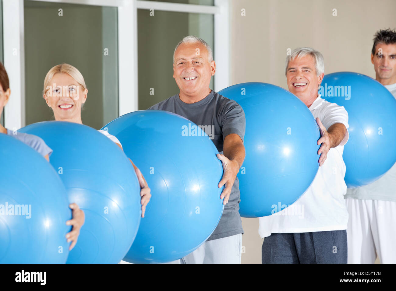 Happy senior group doing fitness exercises with blue gym balls Stock ...