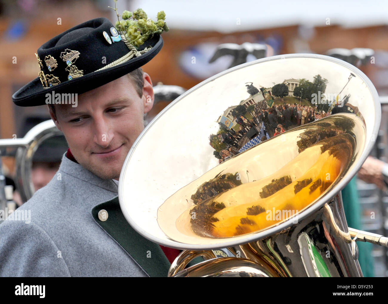 The Bavaria monument is reflected in a brass horn of a musician before ...