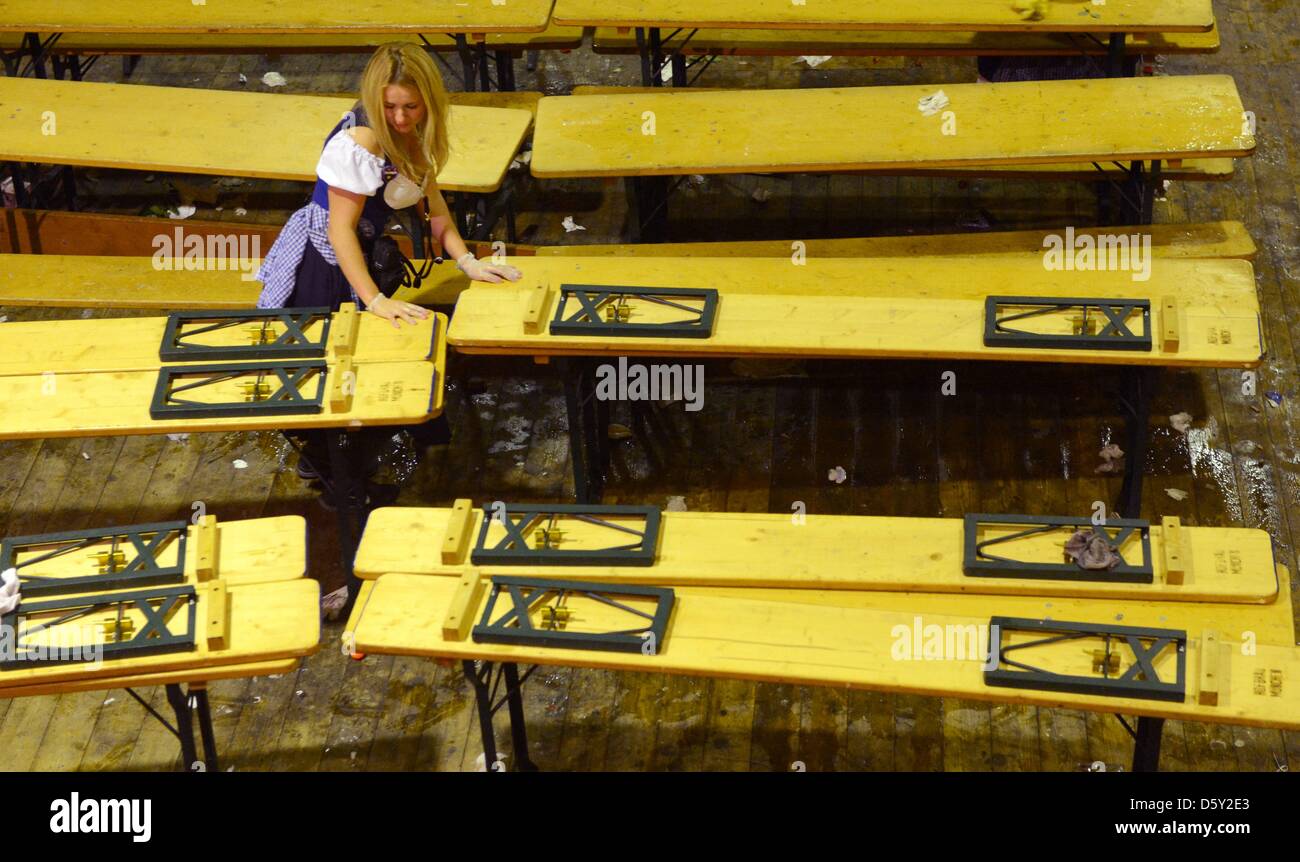 A waitress cleans ale-benches after the Oktoberfest's traditional clean ...