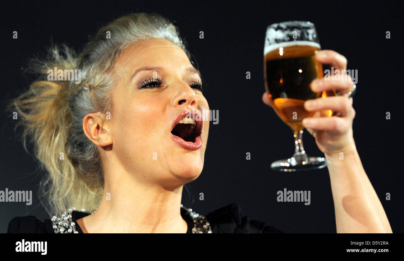 Presenter and singer Ina Mueller toasts with a glass of beer during the ...