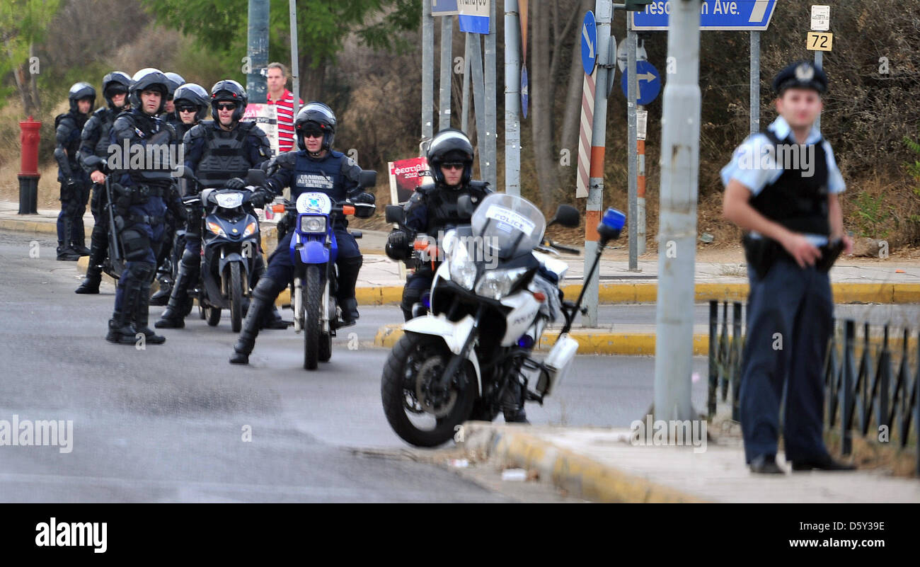 Police officers secure the route of German Chancellor Angela Merkel in ...
