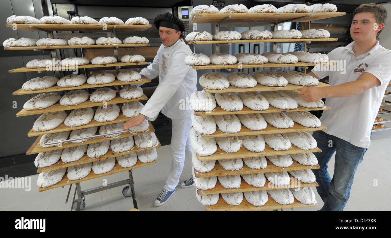 Baker Ronald Morenz (L) and his son Martin (R) present the first ...