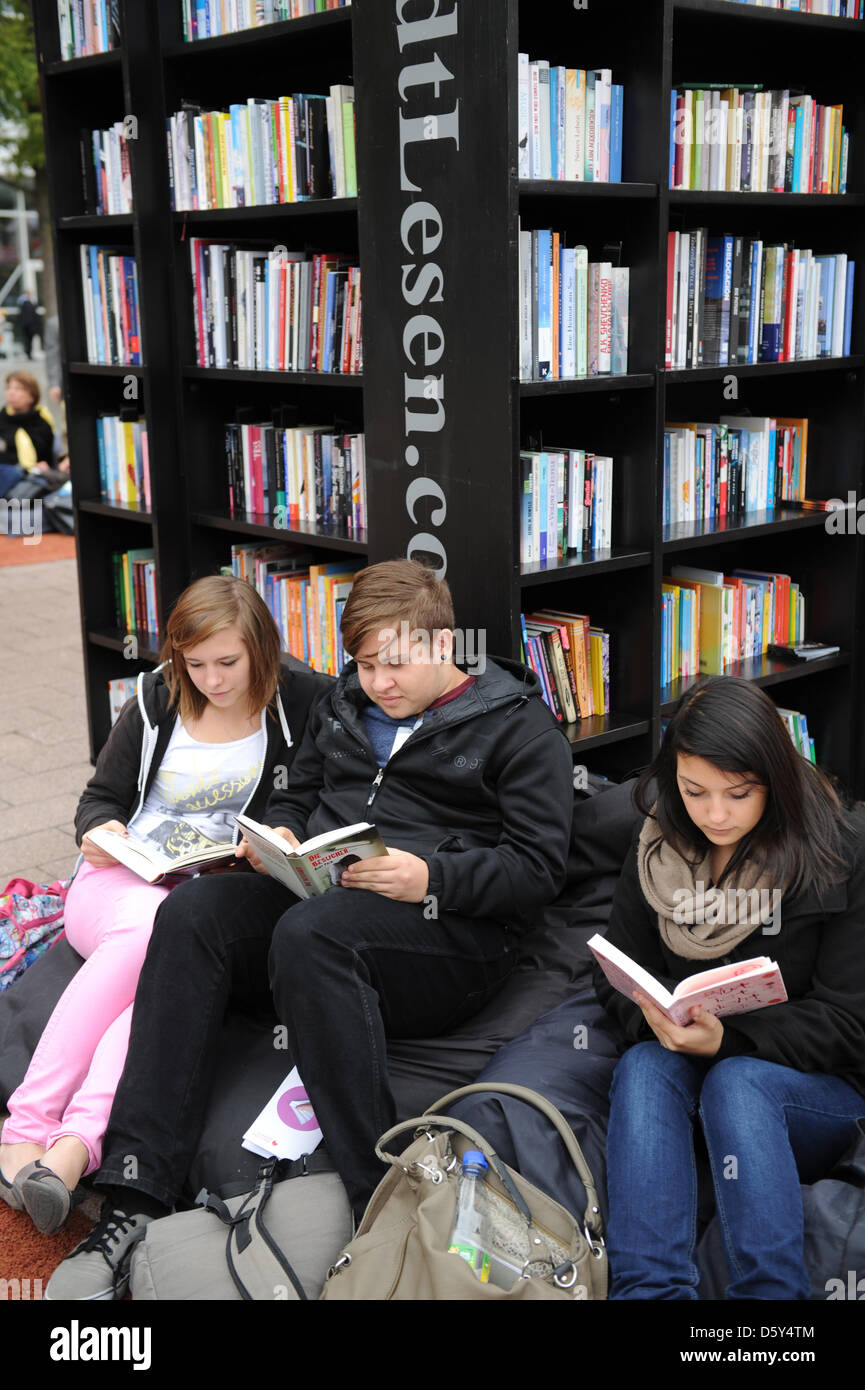Visitors sit at the open-air library at the Frankfurt Book Fair in ...