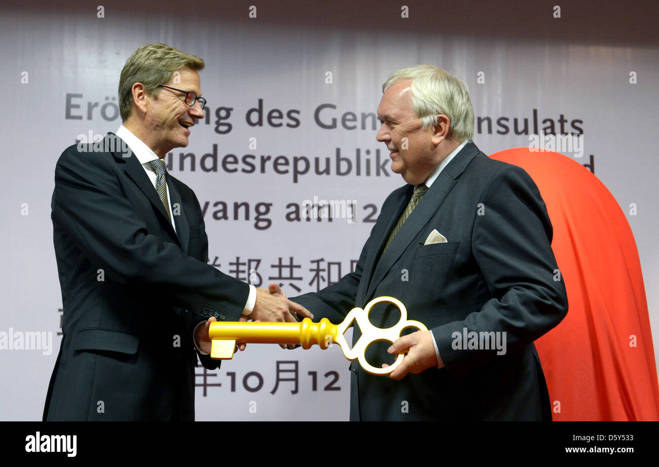 German Foreign Minister Guido Westerwelle (L) hands over a symbolic key ...