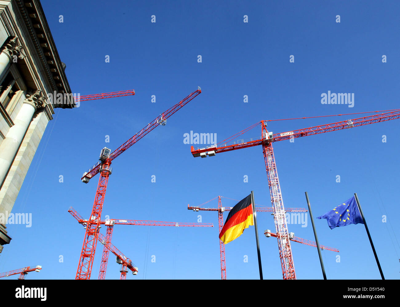 A European and a German flag are visible between cranes at the ...