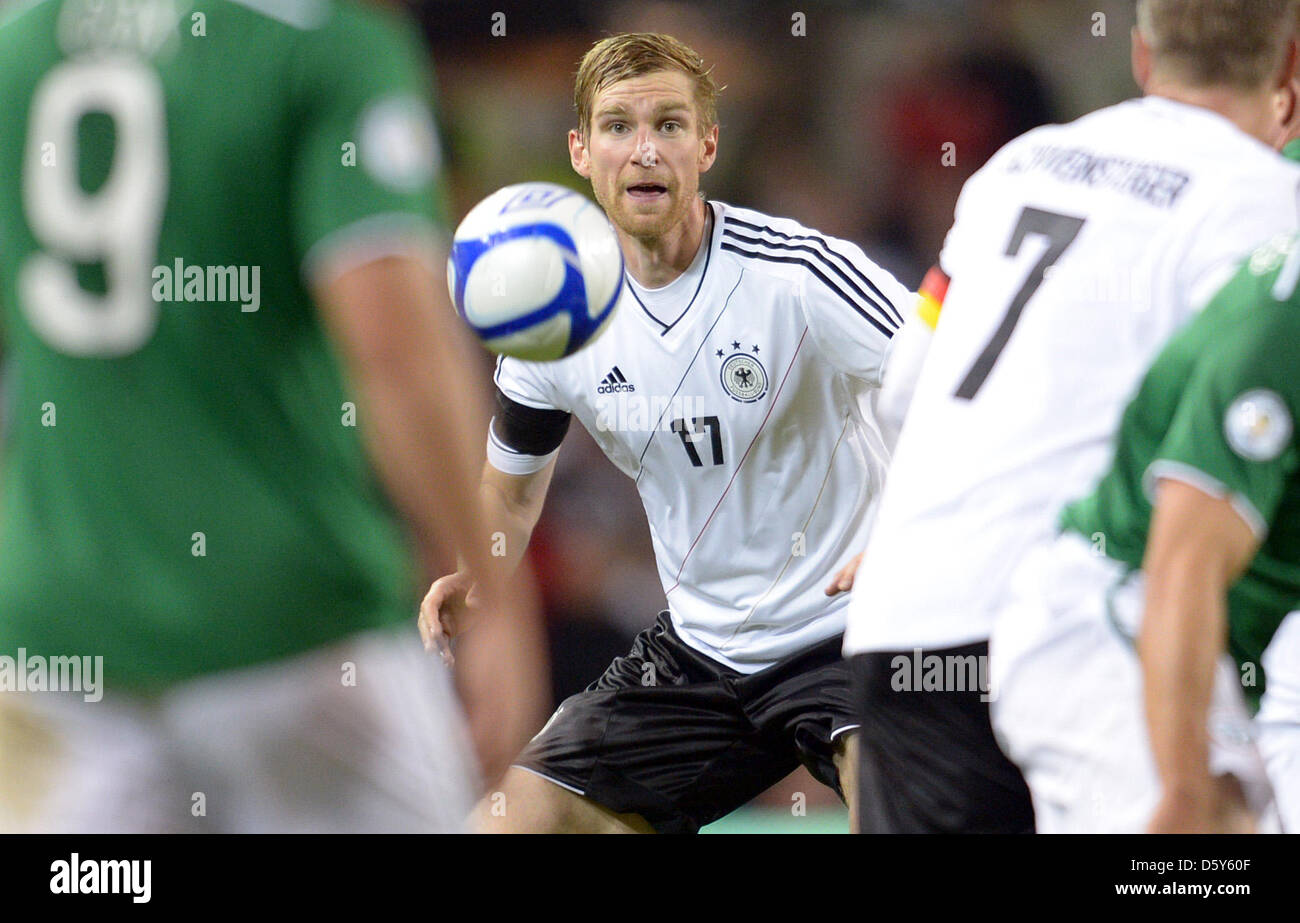 Germany's Per Mertesacker (C) views the ball during the FIFA World Cup ...