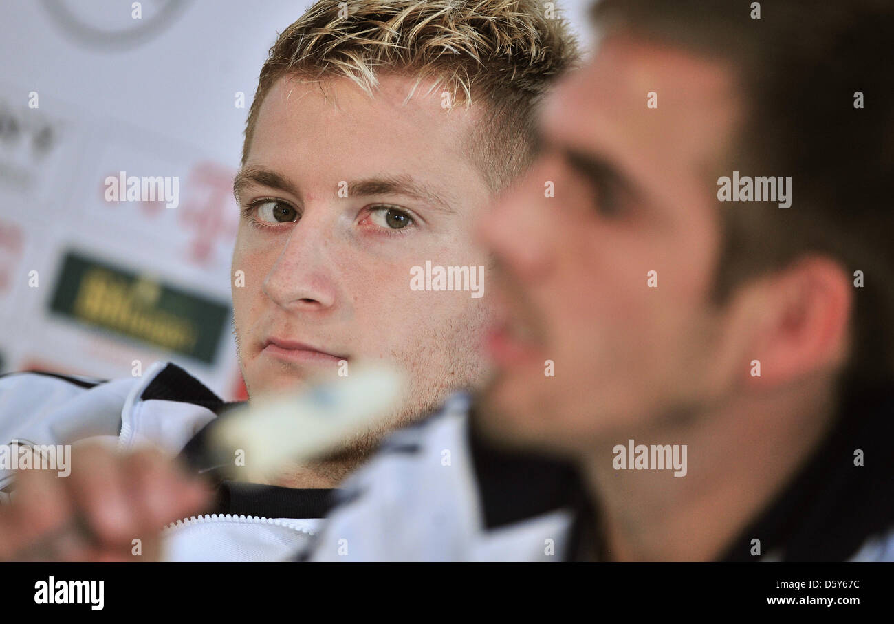 Marco Reus (L) and Philipp Lahm speak at a press conference of the ...