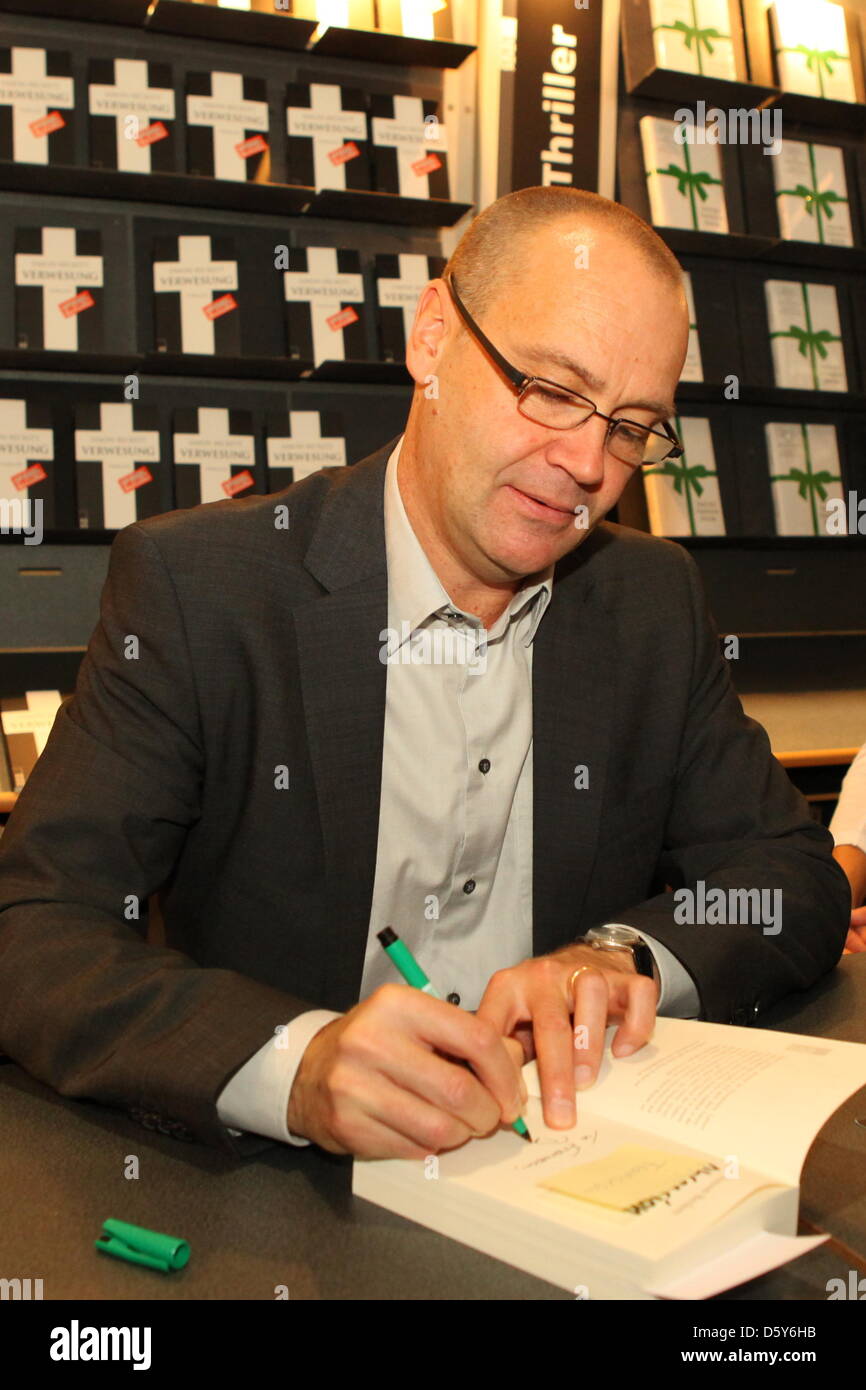 British writer Simon Beckett signs autographs during the presentation ...