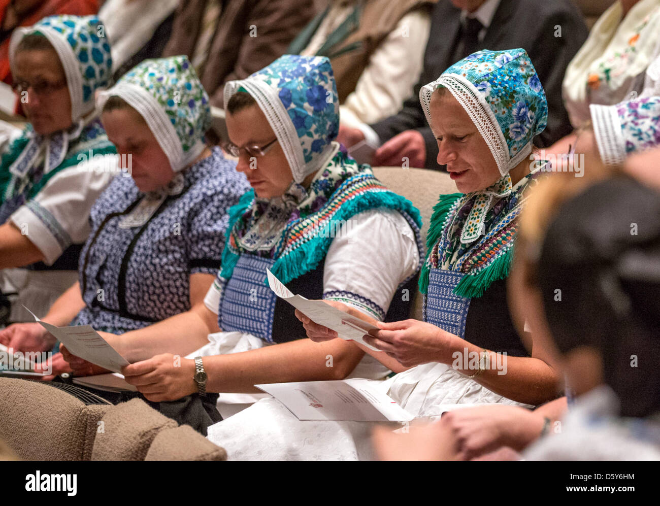 Women wearing Sorbian traditional costumes sit at the Lausitzhalle in ...