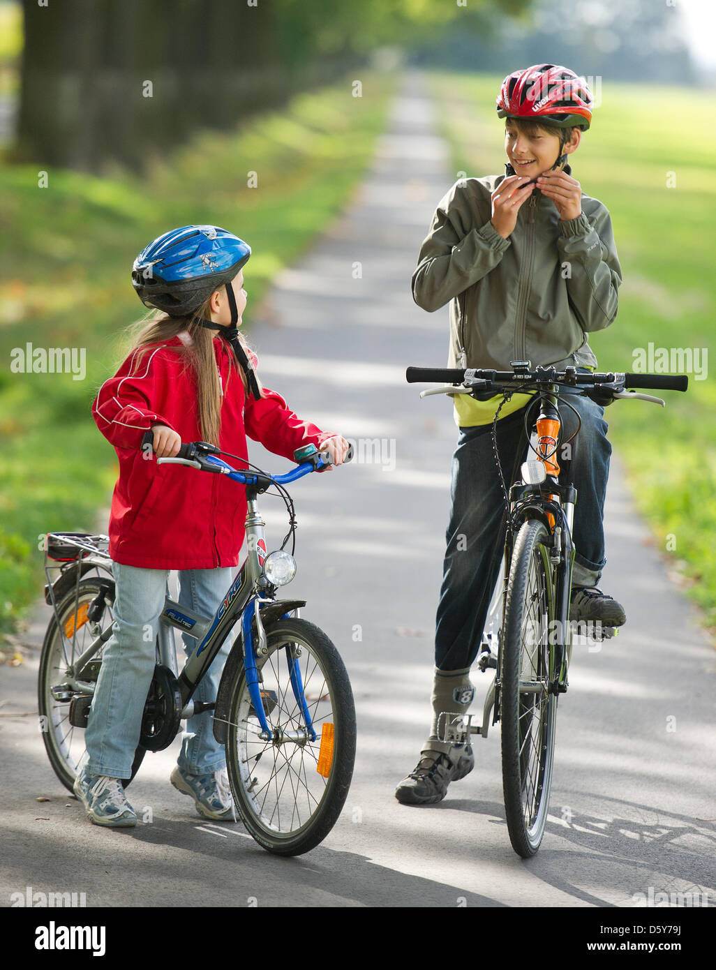 Sibings with bicycles and helmets are pictured in Sieversdorf, Germany ...