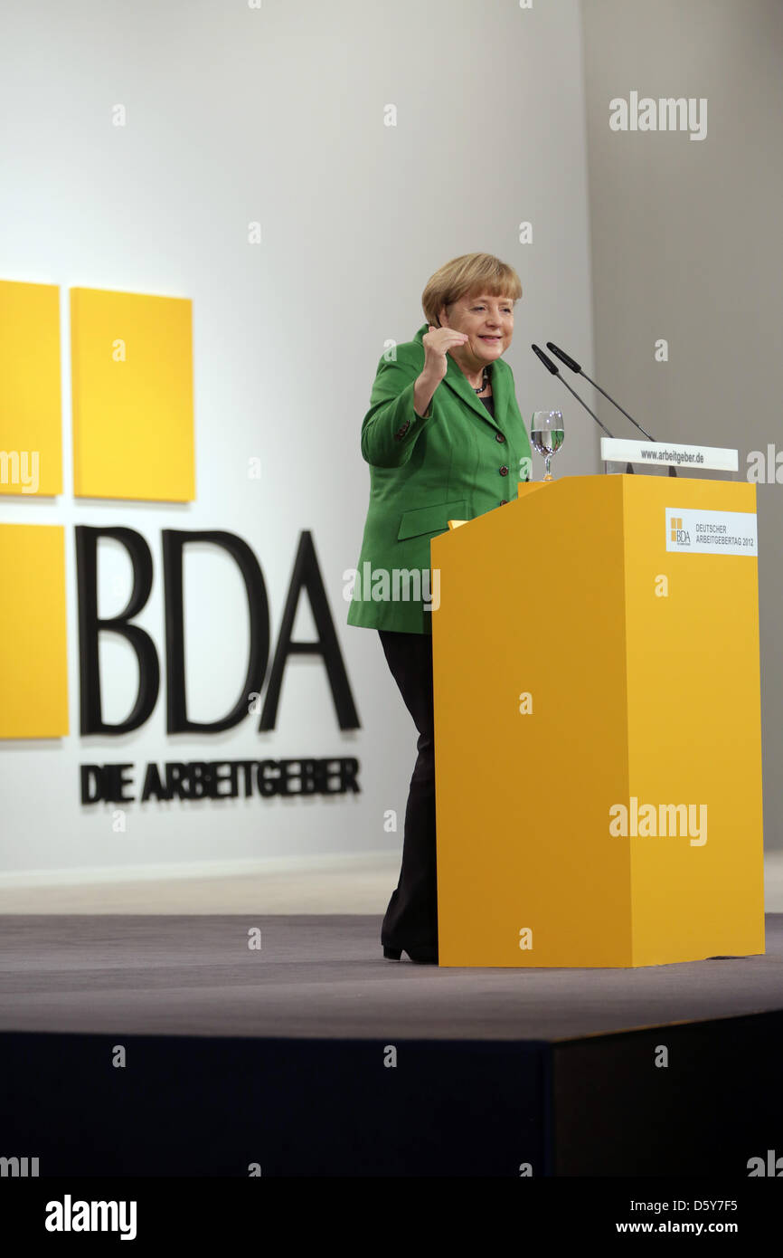 German Chancellor Angela Merkel enters the podium to deliver a speech ...