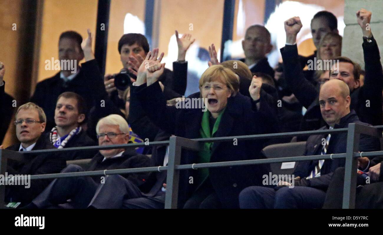 German chancellor Angela Merkel (C) cheers during the FIFA World Cup ...