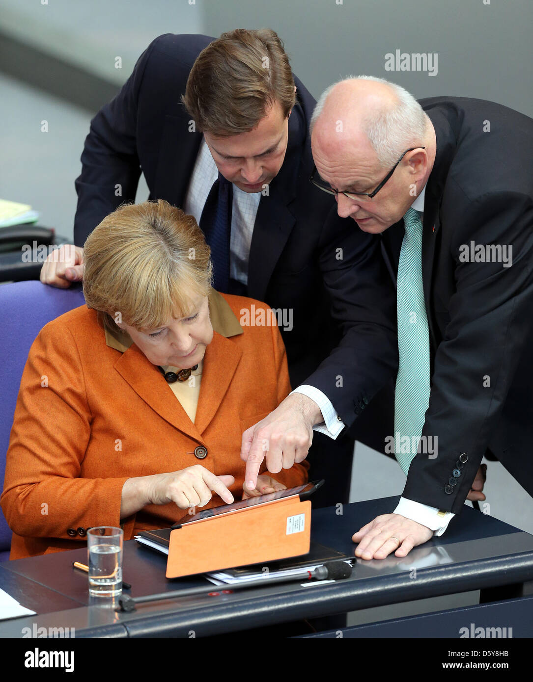 German Chancellor Angela Merkel (L-R) talks to government spokesman ...