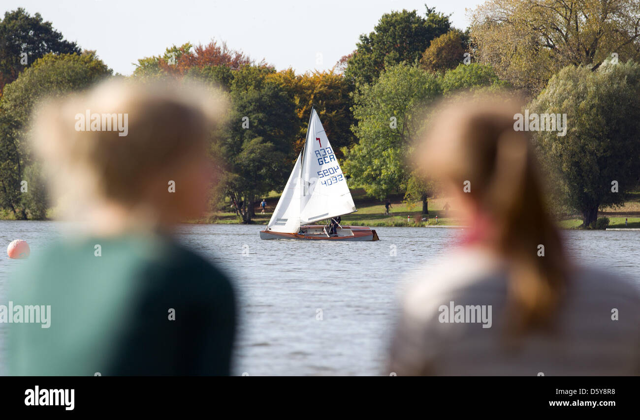 People sit and enjoy the warm autumn weather with temperatures over 20 ...