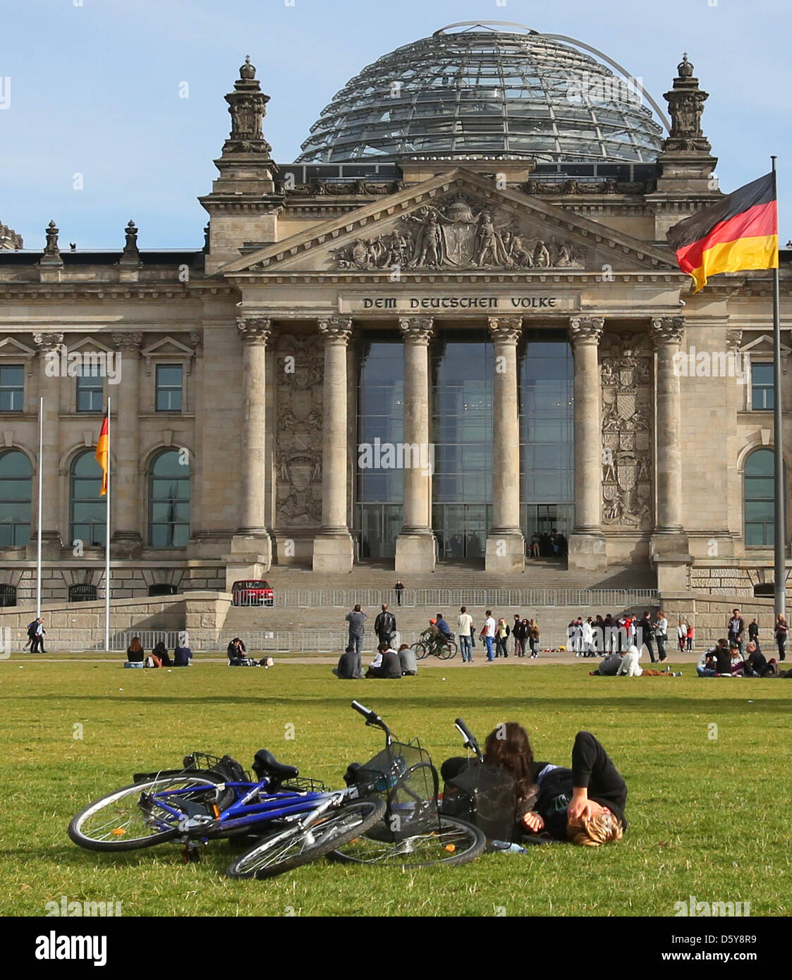 People sit on the grass in front of the Reichstag with 20 degree ...