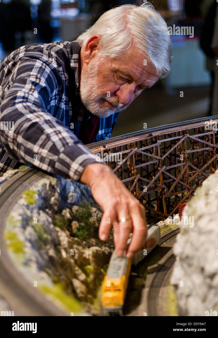 A man puts a model train on the tracks during the 4th international ...