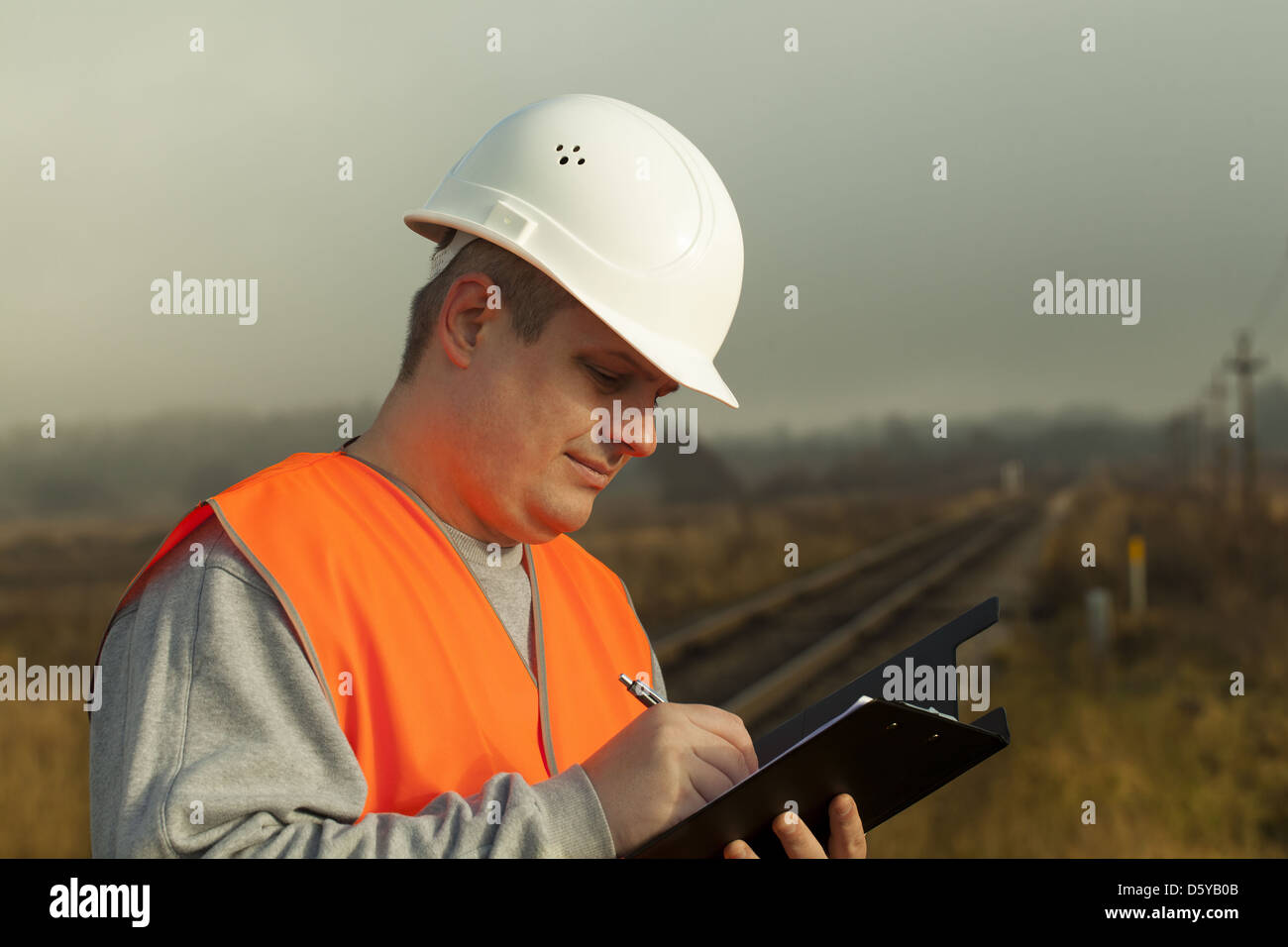Railroad employee with a folder Stock Photo - Alamy