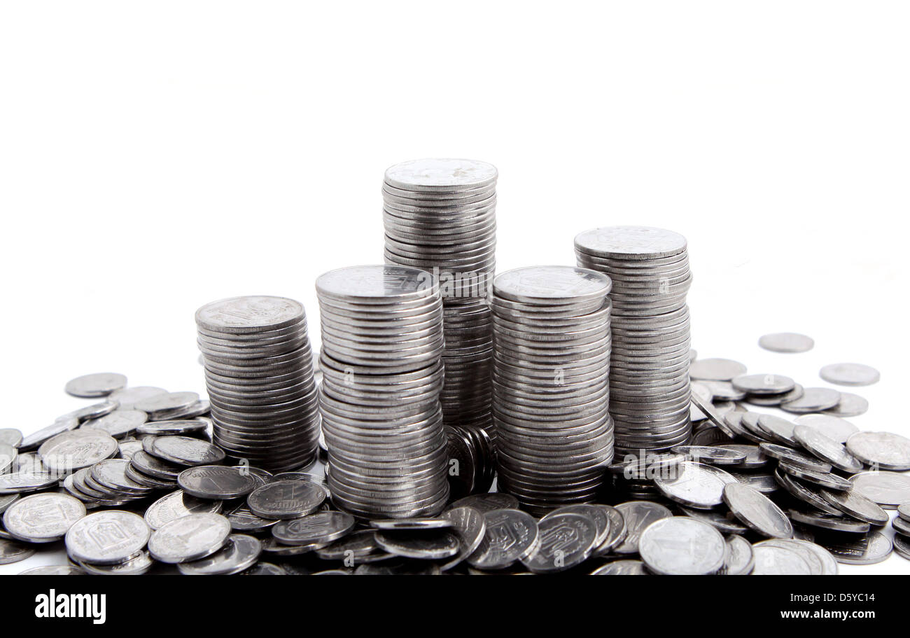 Silver coins are staying in the piles Isolated on white background ...
