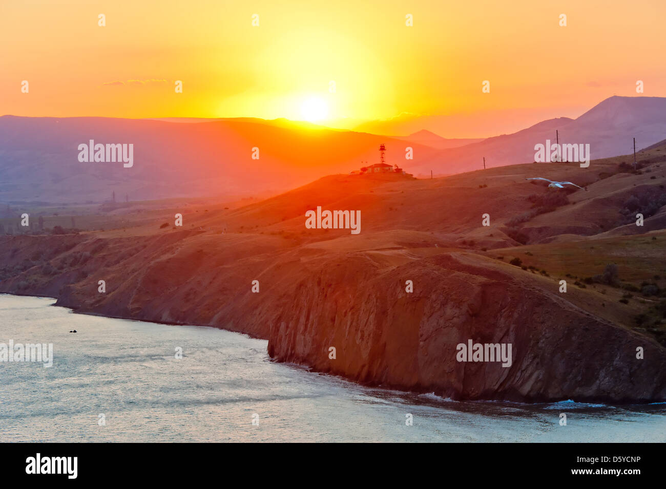 Steep cliff at the edge of the sea at sunset hi-res stock photography ...