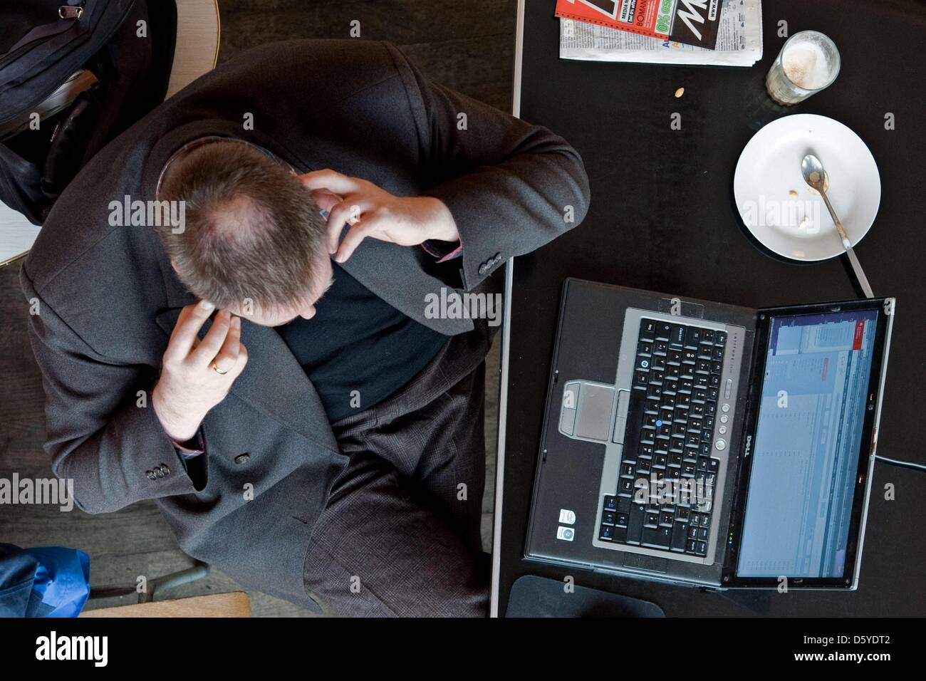 A man sits in front of a his laptop to surf the internet in the ...